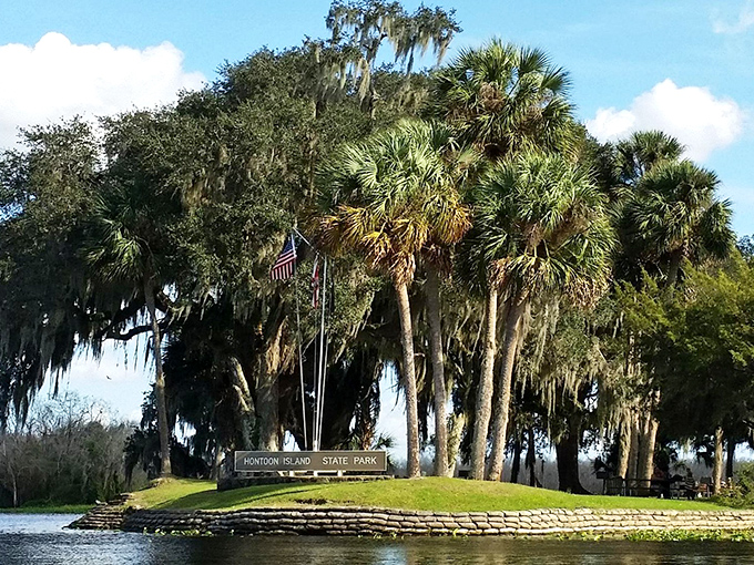 Welcome to Hontoon Island State Park, where palm trees stand sentinel and Spanish moss waves hello from above the entrance sign.