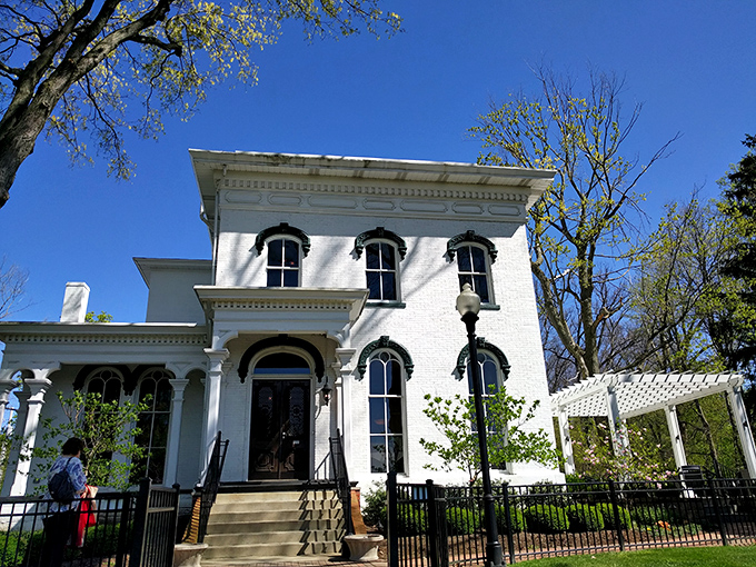 The grand white Italianate fa&ccedil;ade of Hart Mansion stands proudly against a blue Ohio sky, promising culinary adventures within its historic walls.