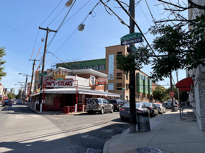 The iconic red and white brick corner of Pat's King of Steaks stands like a culinary lighthouse, guiding hungry pilgrims to cheesesteak nirvana.