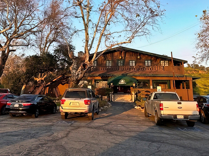 The Sycamore Inn's rustic wooden exterior and iconic green awning welcome hungry travelers along historic Route 66, promising carnivorous delights within.