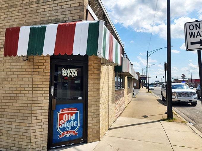 The iconic red, white, and green awning announces "serious Italian food happens here" before you even reach the door. Old Style sign confirms you've found authentic Chicago.