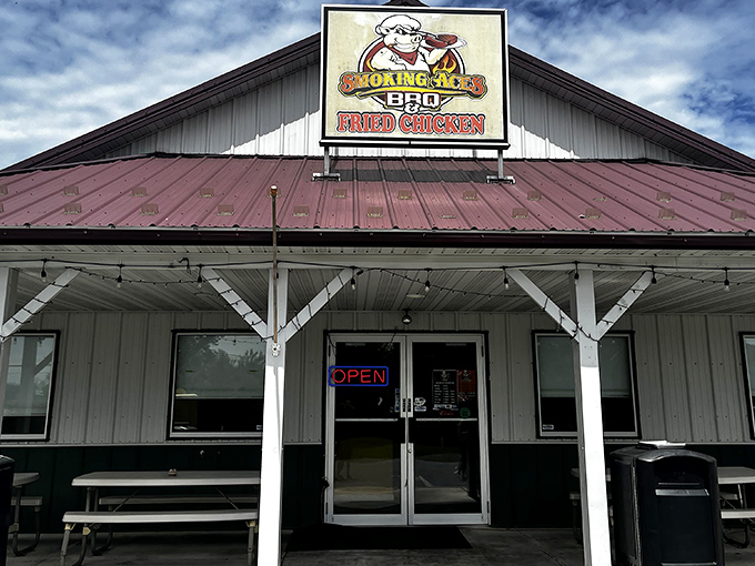 The humble white building with its burgundy roof might not look fancy, but that cartoon pig in sunglasses knows something you don't&mdash;barbecue paradise awaits inside.