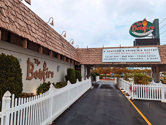 The iconic A-frame entrance to The Bonfire stands like a culinary lighthouse, beckoning hungry travelers with promises of seafood treasures within.