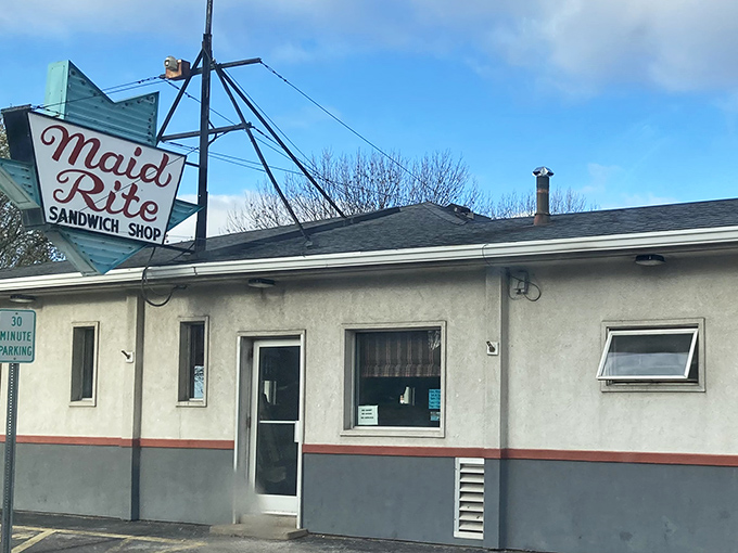 That iconic blue arrow sign beckons like a beacon of comfort food salvation. Midwestern roadside architecture at its most honest and inviting.