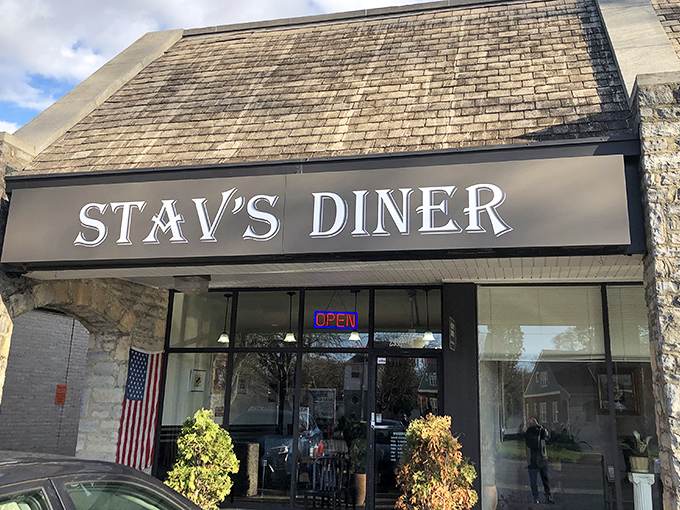 The unassuming storefront of Stav's Diner, where breakfast dreams come true behind that glowing "OPEN" sign. Culinary treasures often hide in plain sight.