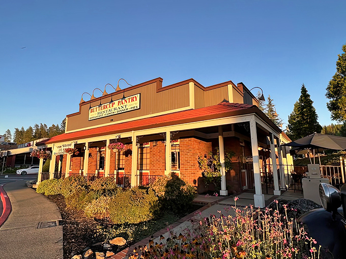 Sunshine meets nostalgia at Buttercup Pantry's brick exterior, where the Gold Rush charm of Placerville welcomes hungry travelers with a promise of comfort food ahead.