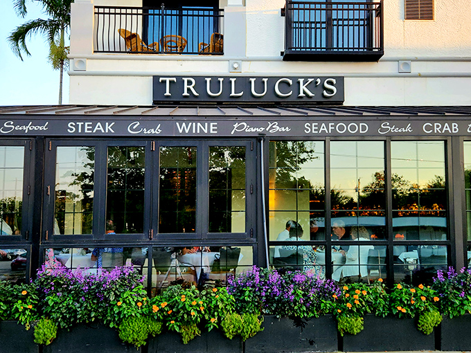 The elegant façade of Truluck's beckons with vibrant flower boxes and a promise of culinary delights within. Naples dining doesn't get more inviting than this.