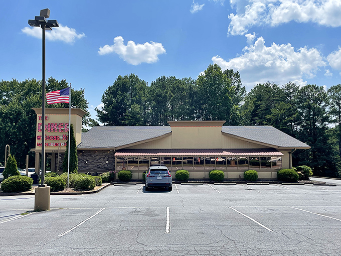 The American flag waves a hearty welcome outside this unassuming treasure. Behind those stone walls and modest exterior lies culinary magic worth discovering.