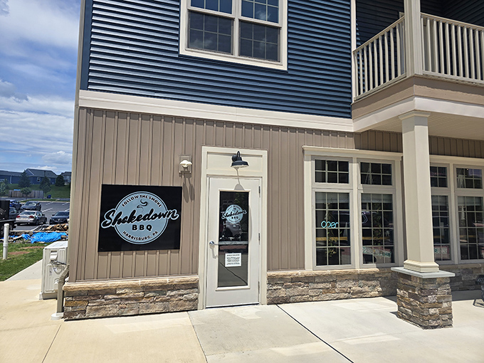 Stone accents and modern lines create a surprisingly sophisticated entrance that whispers "serious barbecue lives here."