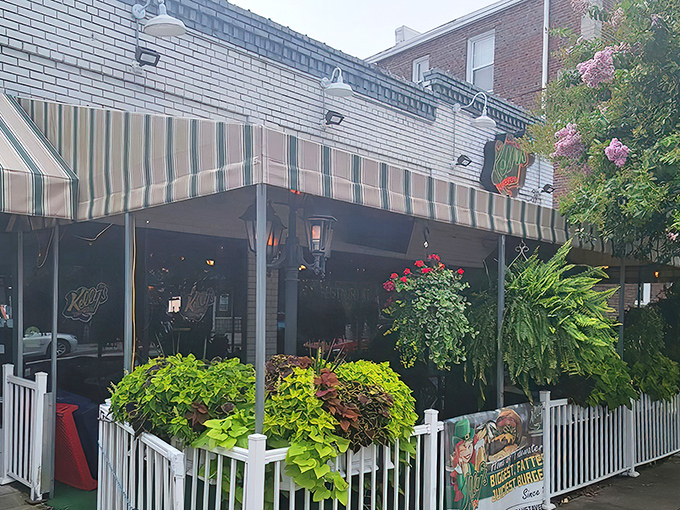 The welcoming fa&ccedil;ade features vibrant flower boxes and greenery, making the outdoor patio a coveted spot for people-watching while enjoying a meal.