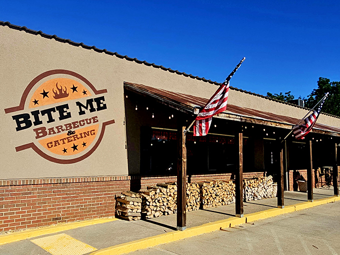 The humble exterior of Bite Me Barbecue promises no frills, just thrills. Those stacked wood logs aren't just decoration&mdash;they're a preview of smoky delights to come.