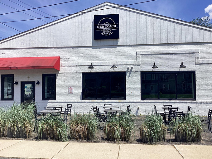The unassuming white brick exterior of Red Coach Donuts proves once again that culinary treasures often hide in plain sight.