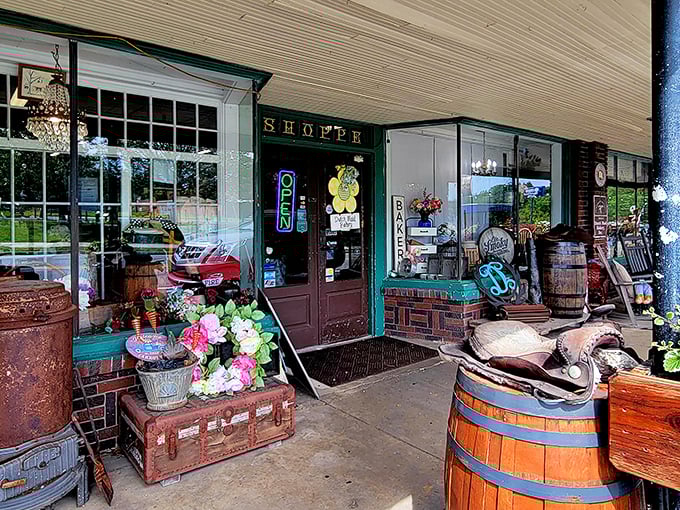 The charming storefront of Dutch Maid Bakery welcomes visitors with rustic barrels, vintage trunks, and that glowing "OPEN" sign promising delicious treasures within.
