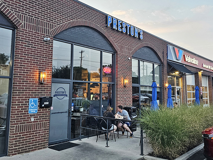 Twilight at Preston's &ndash; when the neon sign glows and hungry pilgrims gather for their burger benediction. The brick archways welcome all seekers of smashed-patty perfection.