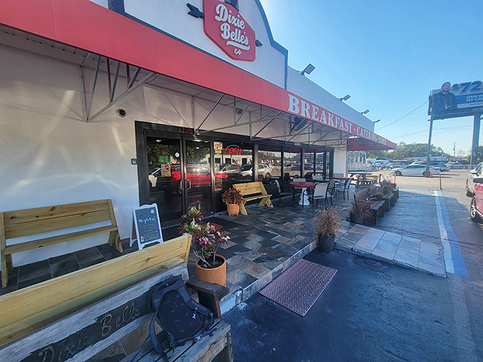 The iconic red and white exterior of Dixie Belle's Cafe stands as a beacon of breakfast hope in a sea of Orlando tourist traps.