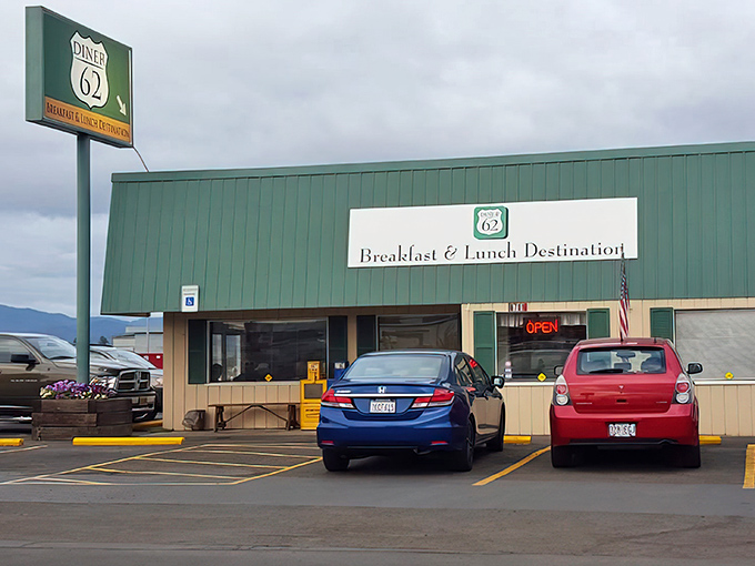 The green exterior of Diner 62 stands like a beacon for hungry travelers, promising comfort food salvation just off the highway.