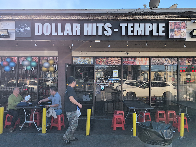 The unassuming storefront of Dollar Hits with its bright red plastic chairs might not scream "culinary destination," but your taste buds are about to have their minds blown.