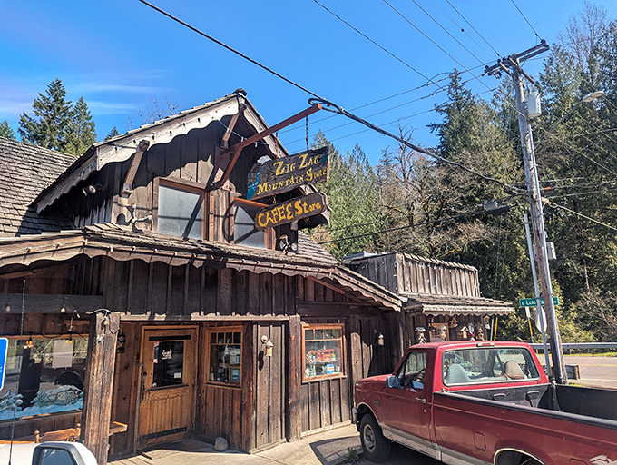 The weathered wooden facade of Zigzag Mountain Cafe stands like a time capsule from Oregon's frontier days, beckoning hungry travelers with rustic charm and the promise of mountain-sized portions.