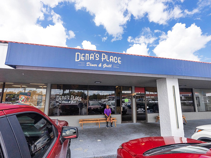 A simple wooden bench outside Dena's Place &ndash; where the brief wait for a table becomes part of the experience. Florida's hidden gems often come with the most unassuming entrances.