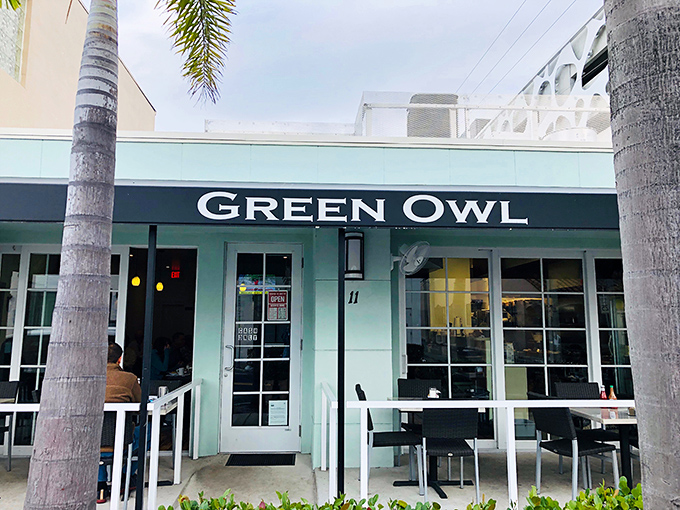 The mint-green exterior of Green Owl stands like a culinary lighthouse amid Delray's palms, promising breakfast treasures for those in the know.