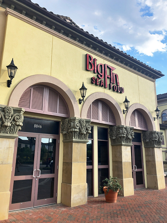 The Mediterranean-inspired fa&ccedil;ade of Big Fin Seafood beckons like a coastal oasis amid Orlando's sea of theme park dining options.