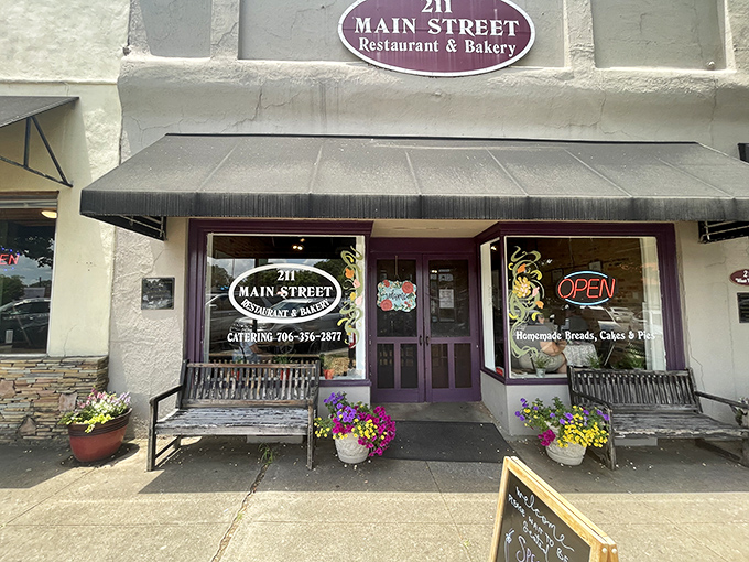 A different angle reveals the restaurant's striped awning and blue chairs – Southern hospitality's front porch, reimagined for downtown Lavonia.