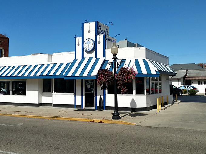 That iconic blue and white striped awning isn't just eye-catching&mdash;it's a time portal to when diners were the heart of American towns.