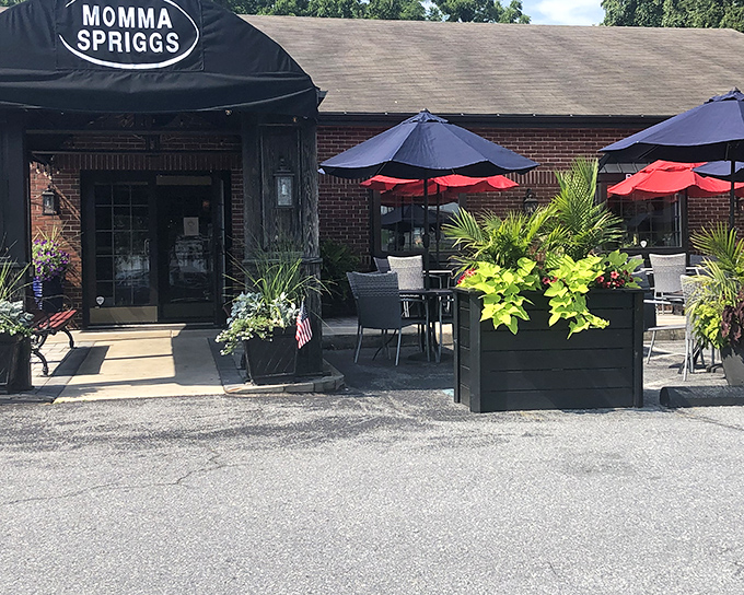 The unassuming brick exterior hides culinary treasures within, like finding a vintage Rolex at a yard sale. Those colorful umbrellas promise relaxation ahead.