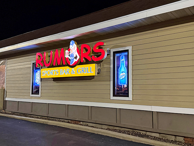 The neon glow of Rumors' sign serves as a beacon for hungry travelers, promising cold drinks and that legendary Wisconsin fish fry within.