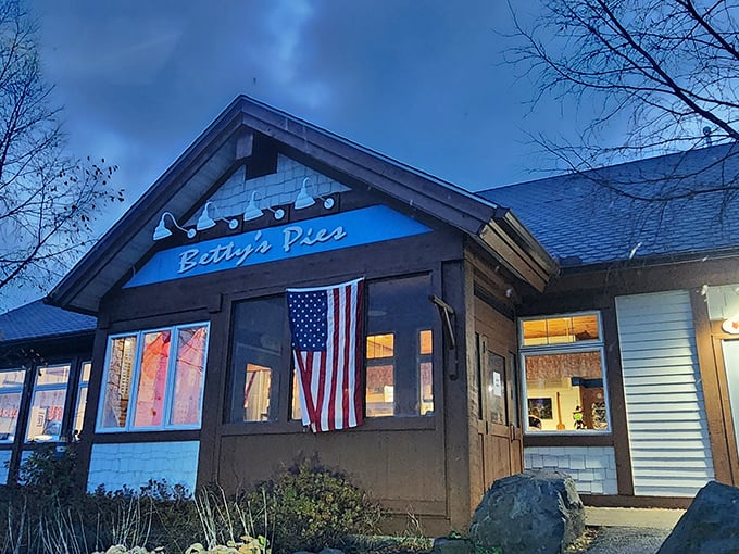 The blue-signed beacon of Betty's Pies stands proudly against the Minnesota sky, American flag waving as if to say, "Yes, patriotism can taste like dessert."