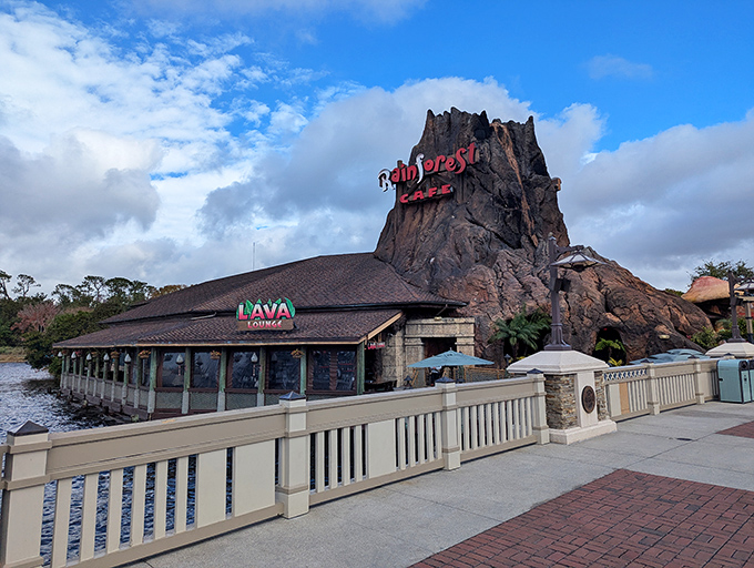 The iconic volcano exterior of Rainforest Cafe rises majestically over Disney Springs' waterfront, promising adventure before you even step inside.