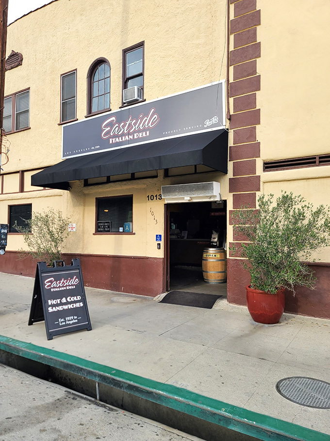 The unassuming facade of Eastside Italian Deli beckons like an old friend, promising culinary treasures behind that classic maroon and cream exterior.