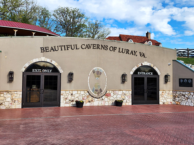 The welcoming entrance to Luray Caverns promises underground wonders that make your childhood blanket fort look like amateur hour.