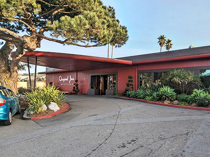 Palm trees frame this California classic, where the distinctive coral facade has welcomed hungry patrons for generations of memorable meals.