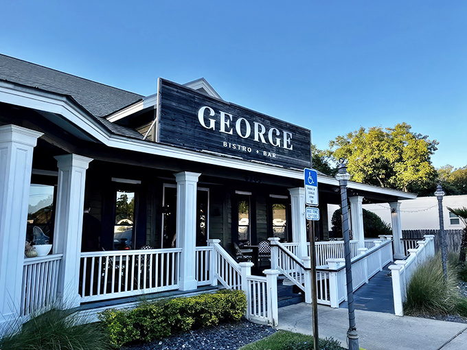 The striking contrast of black signage against white columns creates that perfect first impression &ndash; sophisticated yet approachable, like a tuxedo with flip-flops.