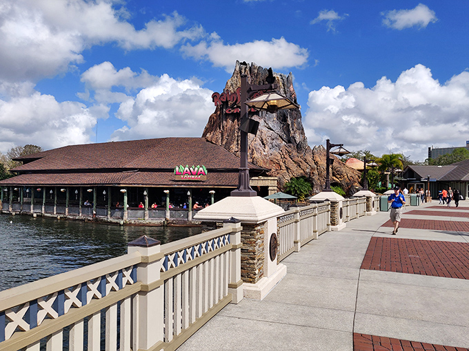 The iconic volcano exterior of Rainforest Cafe rises majestically over Disney Springs' waterfront, promising adventure before you even step inside.