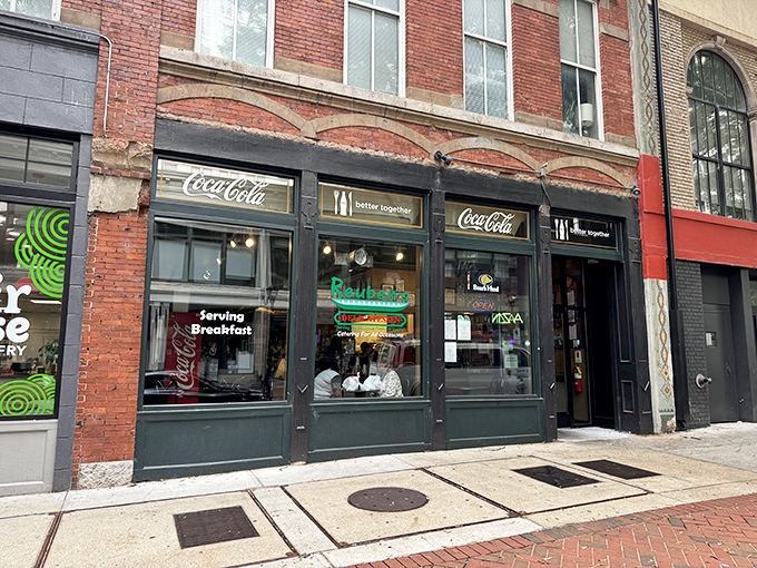 The unassuming brick façade of Reuben's Deli in downtown Atlanta – where sandwich greatness hides behind Coca-Cola signs and zero pretension.