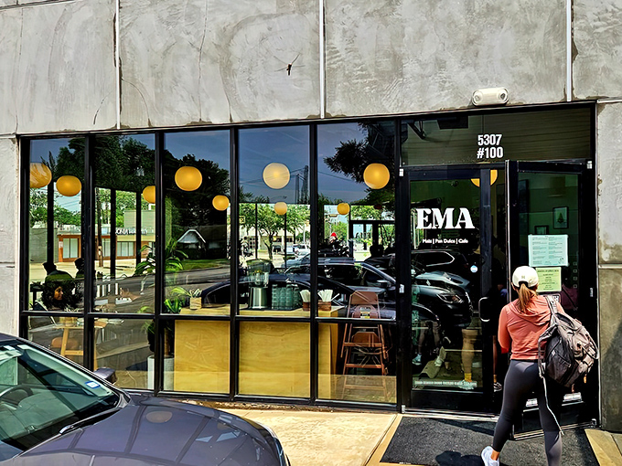 The modern storefront beckons with warm globe lights and a sleek design. Like finding a secret doorway to flavor paradise in suburban Houston.