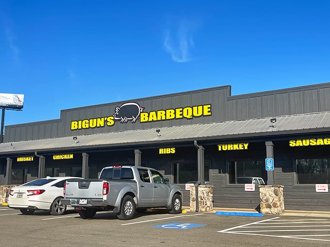 The unassuming exterior of Bigun's Barbeque stands like a beacon of smoky promise against the Georgia sky, its bold yellow signage a siren call to hungry travelers.