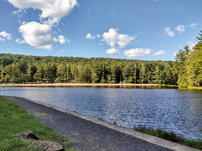 Nature's perfect mirror: the lake at Raymond B. Winter State Park reflects towering pines and puffy clouds like Mother Nature's own Instagram filter.