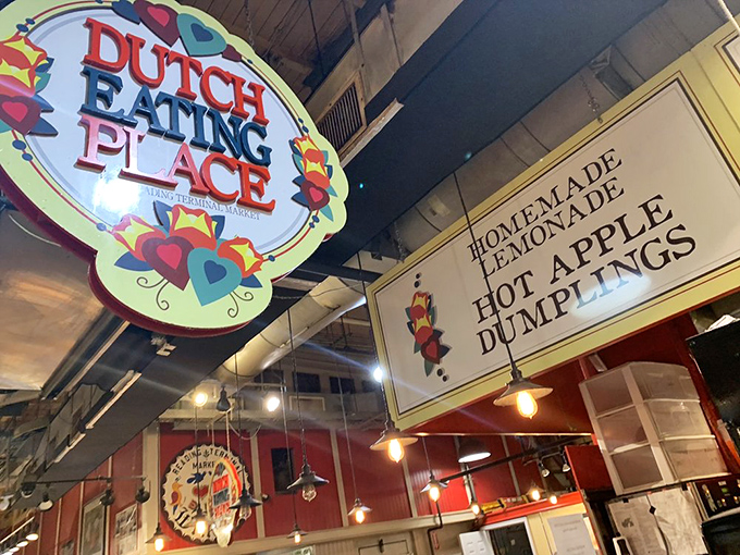 The colorful heart-adorned sign promises comfort before you've taken a single bite. Like a beacon of homestyle cooking amid market chaos.