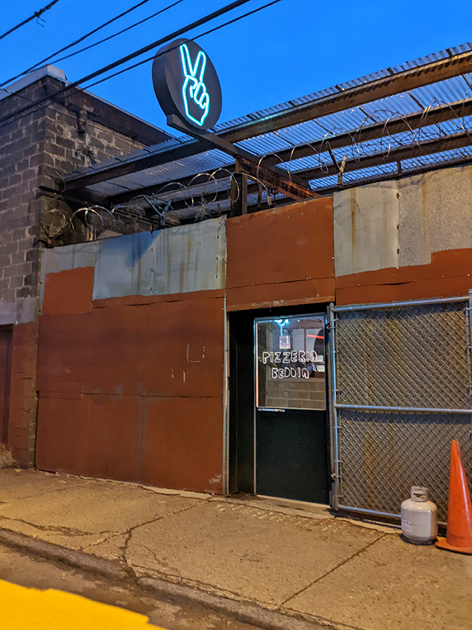 The iconic green peace sign beckons pizza pilgrims to this unassuming Fishtown gem. Proof that greatness often hides behind humble facades.