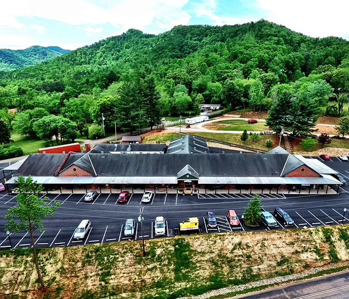 The brick facade of Whistle Stop Shop Depot proudly announces its philosophy with a bright banner: "Antique Furniture Does Not Depreciate!" A treasure hunter's first clue.