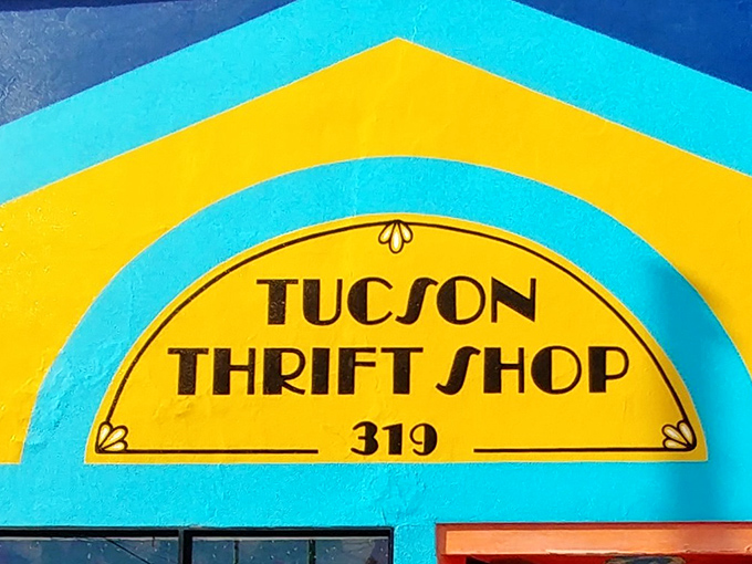 The turquoise facade of Tucson Thrift Shop pops against the desert landscape like a fashion oasis, promising treasures within its vibrant walls.