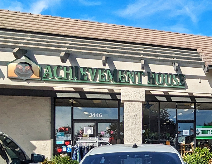 The welcoming storefront of Achievement House beckons with its cheerful owl logo&mdash;like a wise old friend inviting you to discover hidden treasures inside.