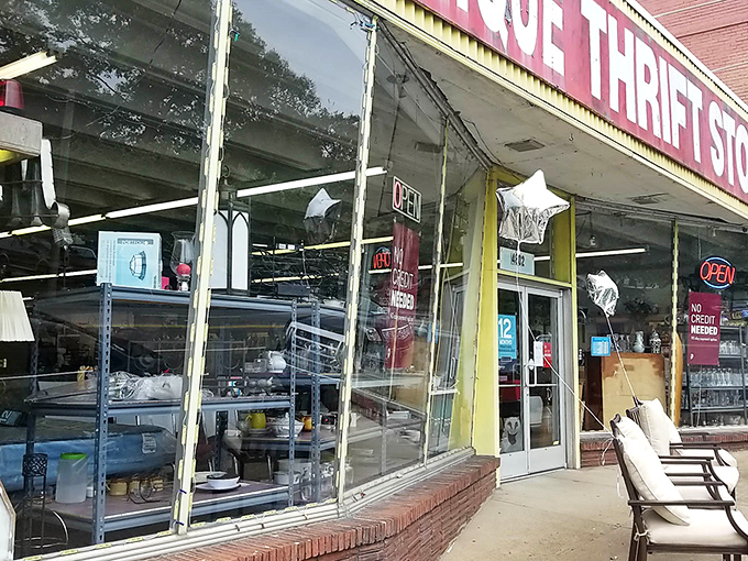 The storefront beckons like a siren song to bargain hunters, its weathered yellow trim and bold red sign promising adventures in secondhand treasures.
