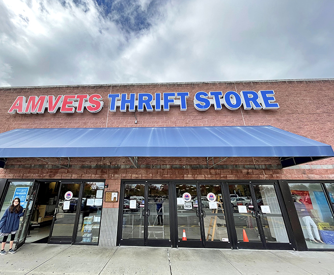 The brick facade and bold red-and-blue signage of AMVETS Thrift Store stands as a beacon for bargain hunters throughout Knoxville.