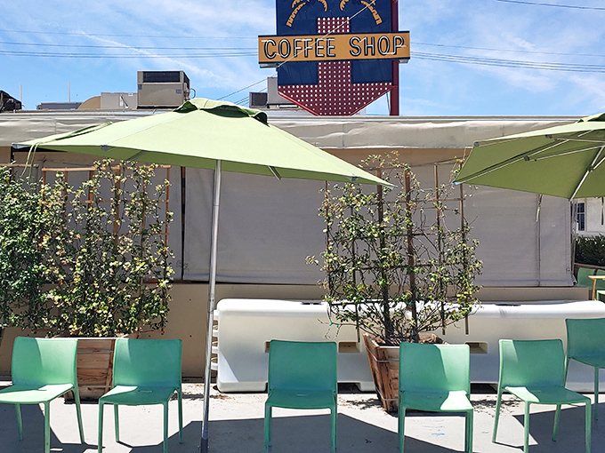 The outdoor seating area, where mint-green chairs wait patiently for hungry patrons like eager puppies hoping for table scraps.