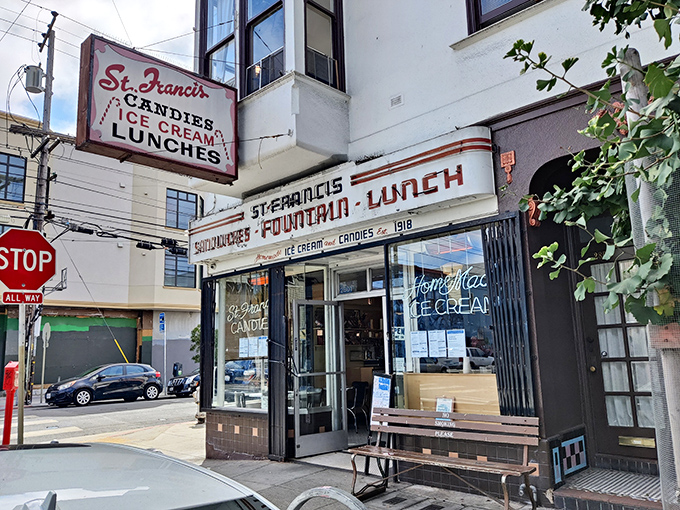 The iconic St. Francis Fountain storefront stands as a time capsule on the corner of 24th Street, its vintage signage promising simple pleasures that never go out of style.
