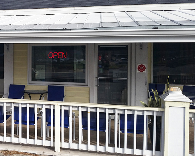 The cheerful yellow exterior with blue accents feels like Florida sunshine in building form. That "OPEN" sign is practically begging you to come in.
